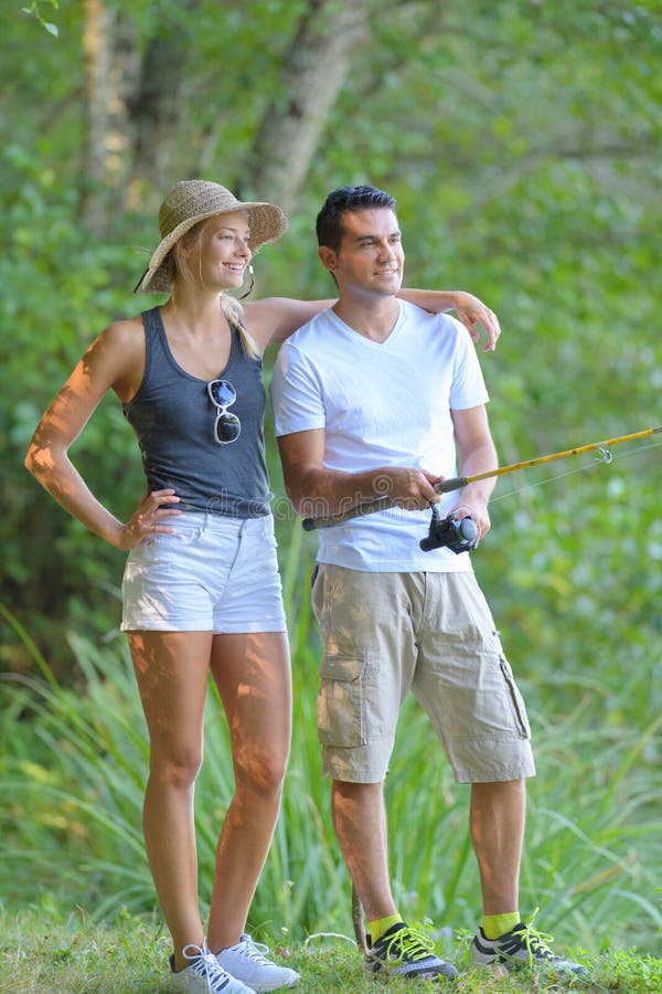 Supporting Partner while Fishing Stock Photo - Image of outdoor, green ...