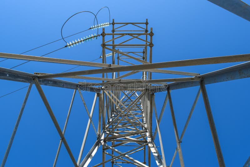 Supports High-voltage Power Lines Against the Blue Sky. View from the ...
