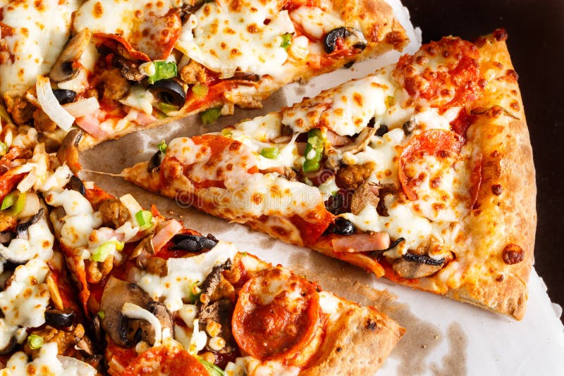 A Slice of Supreme Pizza on Rustic Wooden Table Stock Photo - Image of ...