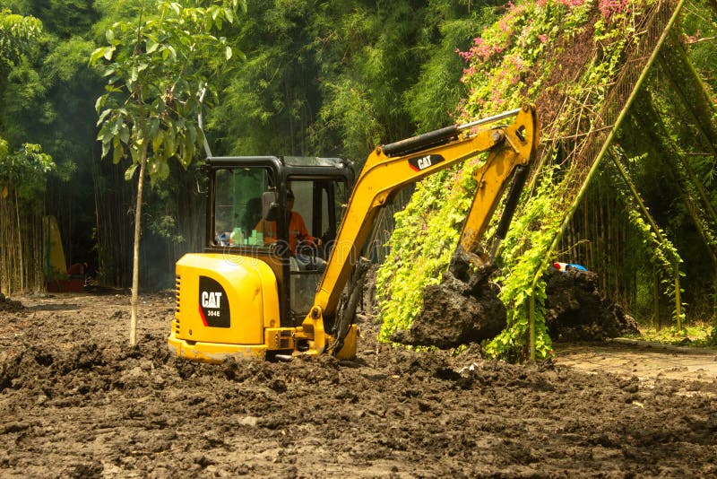 A Worker on Modern Excavator Performs Excavation Work on the ...