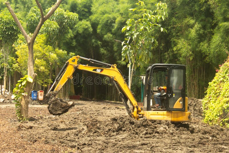 A Worker on Modern Excavator Performs Excavation Work on the ...