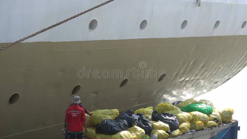Ship Worker Throw Garbage Bag from the Ship into the Garbage Truck ...