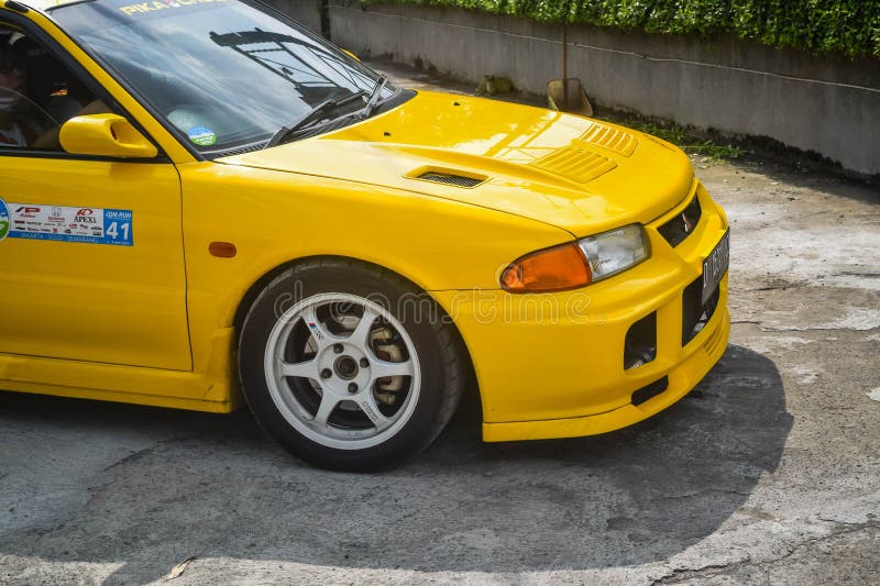 Yellow Mitsubishi Lancer Evolution V in a Car Show Editorial Stock ...