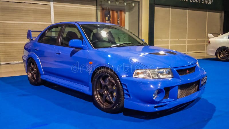 Blue Mitsubishi Lancer Evolution VI Being Displayed in a Car Show ...