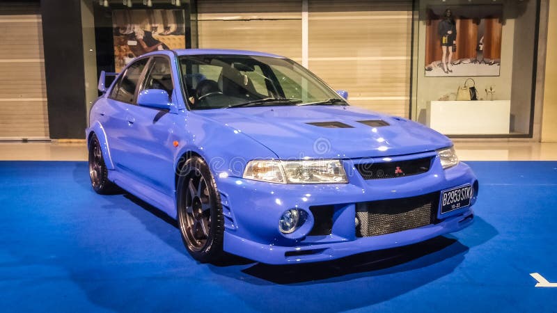 Blue Mitsubishi Lancer Evolution VI Being Displayed in a Car Show ...