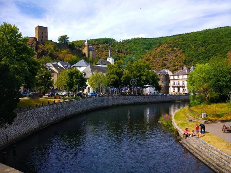 Sure River through Esch-sur-Sure with Esch-sur-Sure Castle at the ...