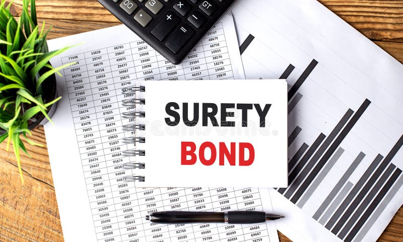 SURETY BOND Text on a Notebook with Chart and Calculator Stock Photo ...