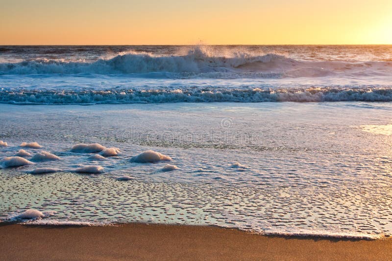 Surf Approaching Beach at Sunrise Stock Photo - Image of foam, daylight ...