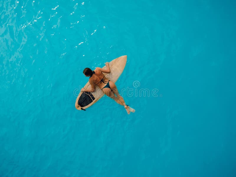 Surf Girl In Bikini Swimming With Surfboard In Ocean Aerial View Of Surfer Woman Stock Image