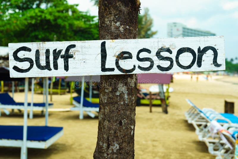 Surf Lessons Sign Nailed To a Tree Stock Image - Image of worn, black ...