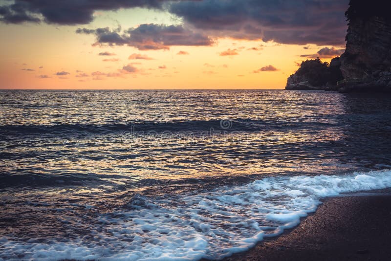 Surf at Sunset Beach with Dramatic Orange Sky and Cliffs on Montenegro ...