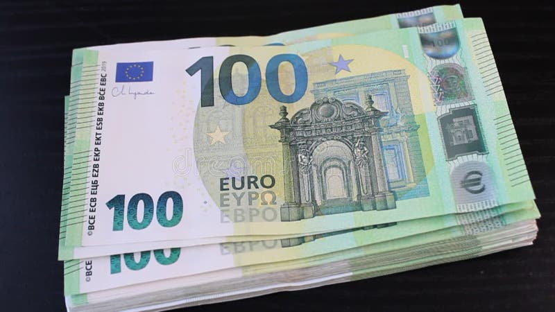 A Stack of 100 Euro Banknotes Falls Freely on the Surface of a Black ...