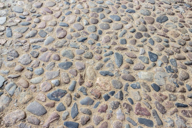 The Surface of the Cobblestone Pavement, Lined with Round Stones Stock ...