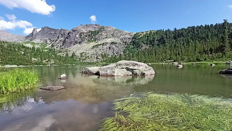 The Surface of a Large Lake in the Mountains with Protruding Stones and ...