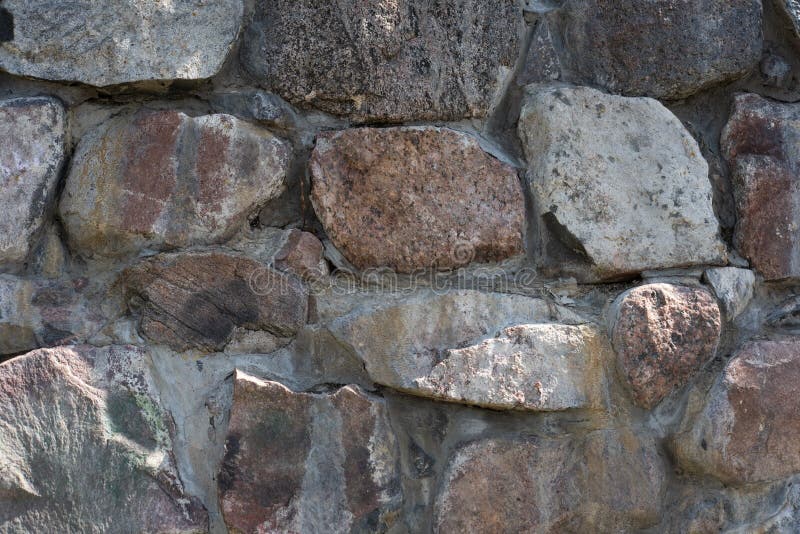 The Surface of the Uneven Stone Wall of Large Cobblestones Stock Image ...