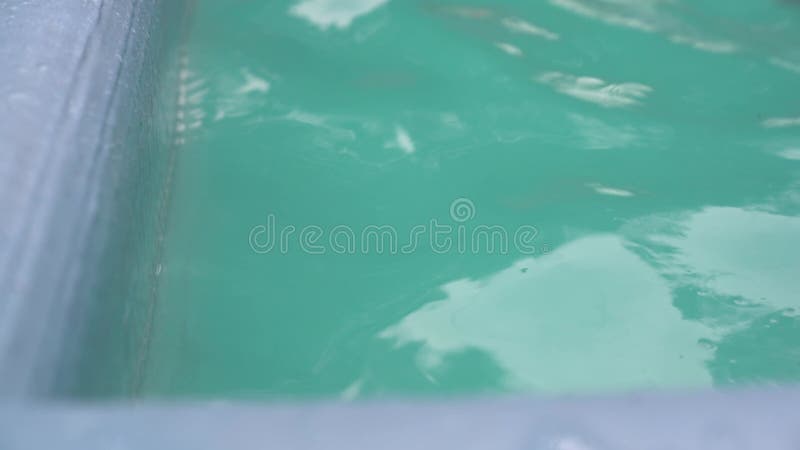 The Surface of the Water with Waves in the Pool is Moving. Ripples with ...