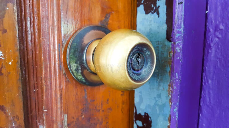 Surface Worn Antique Brass Door Knobs with Surrounding Rough Texture ...