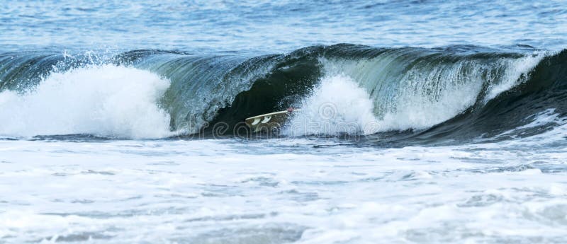 Surfboad is Still in View As a Wave Engulfs a Surfer Stock Image ...