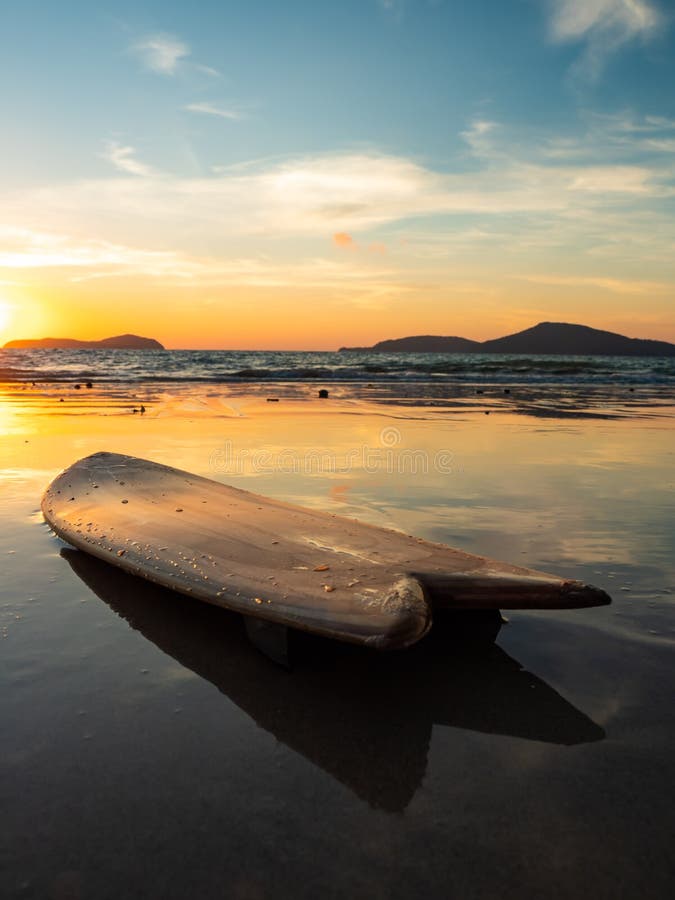 Surfboard on the beach stock photo. Image of sand, sunset - 197702344