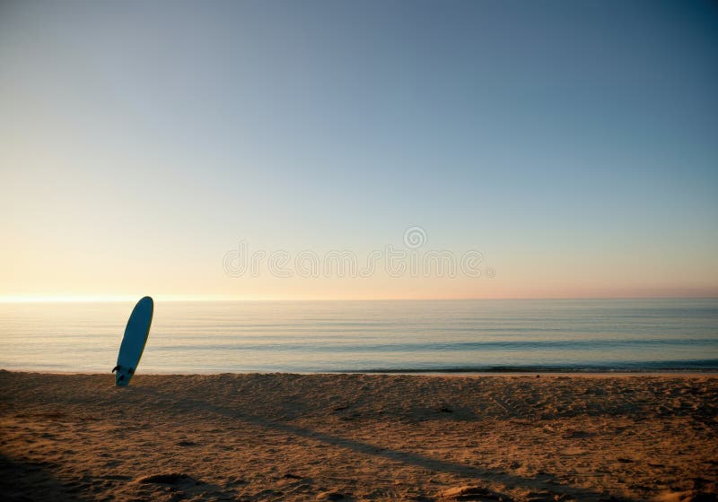 Surfboard Resting on the Sandy Beach at Sunset, Creating a Serene ...