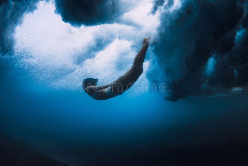 Surfer Girl Dive Underwater with Ocean Powerful and Dangerous Wave ...