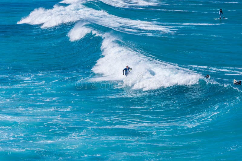 Surfer group in the water editorial stock image. Image of gold - 143940749