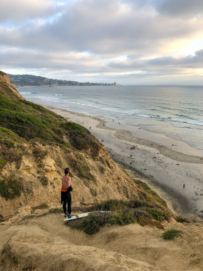 Surfer with His Surf Standing at the Cliff and Looking at the Waves ...