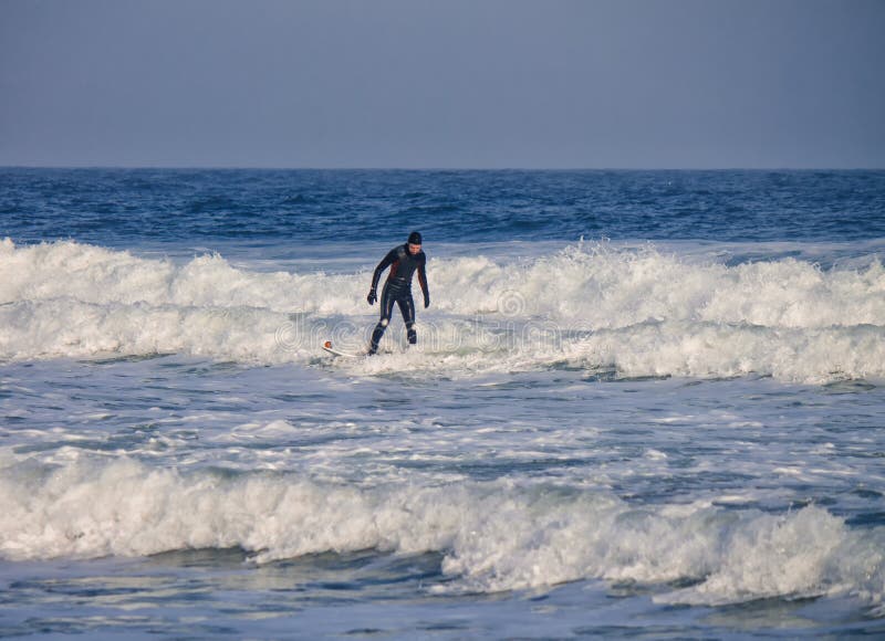 A Surfer Rides Waves in the Water Stock Photo - Image of scenic, sports ...