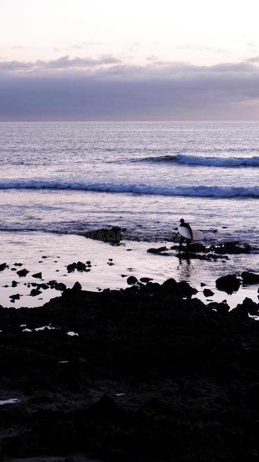Surfer on a Rocky Beach after Sunset Stock Image - Image of nature ...