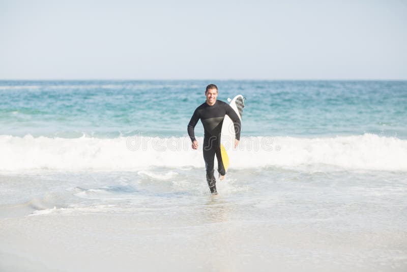 Surfer Running on the Beach with a Surfboard Stock Photo - Image of ...