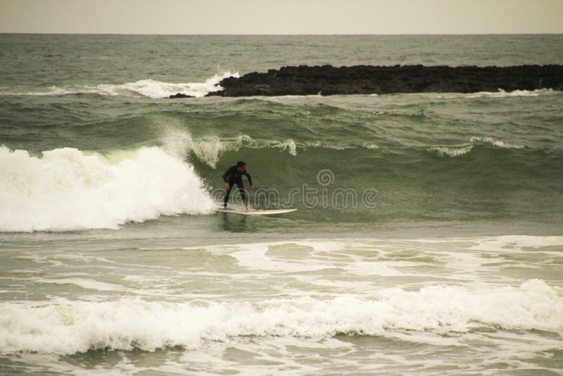 Surfer on the Sea with Big Waves Behind Him Stock Image - Image of ...