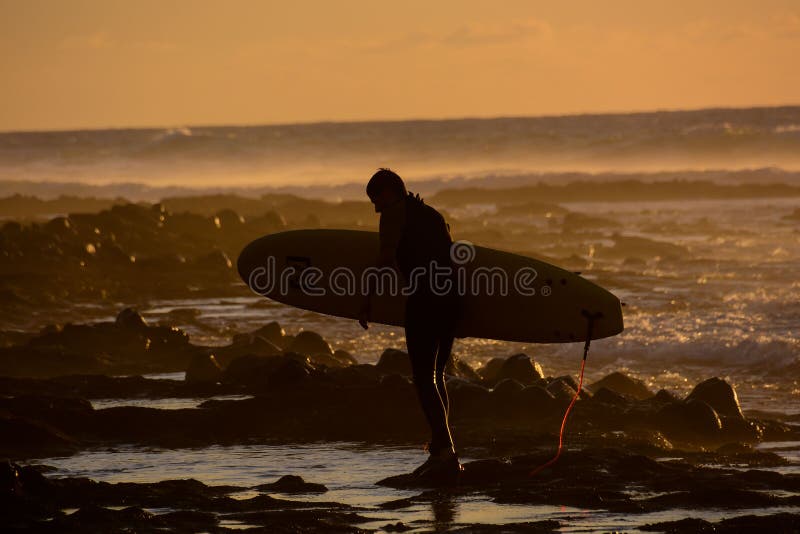 Surfer at Sunset on a Calm Ocean Editorial Photography - Image of ...