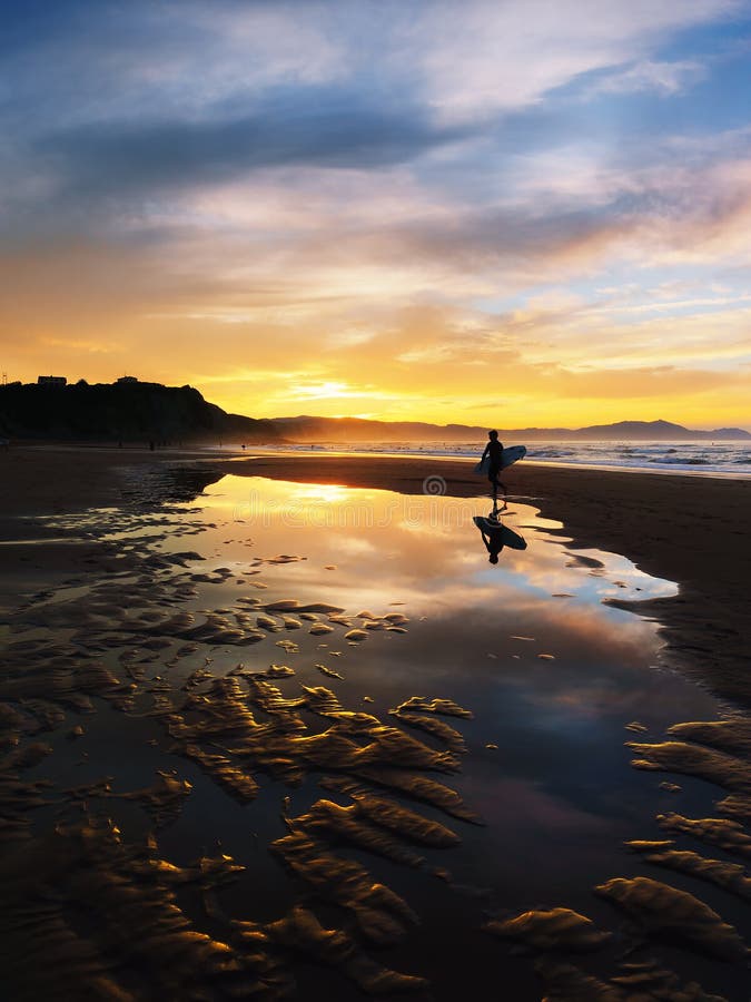 Surfer at Sunset with Reflection on Puddle Stock Image - Image of ...
