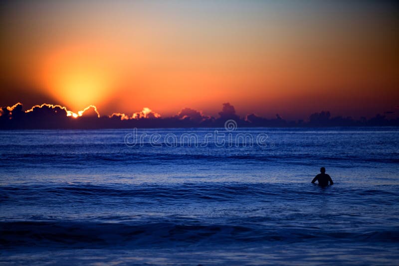 Surfer at sunset stock photo. Image of water, surfer - 58740488