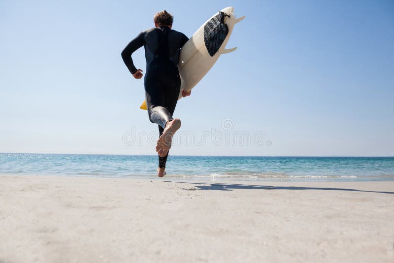Surfer with Surfboard Running Towards the Sea Stock Image - Image of ...