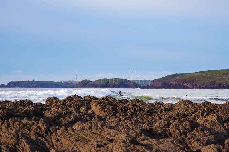 Surfer Surfing at the Freshwater West Beach in Wales with Rocky ...
