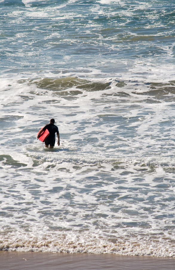 Surfer Wading into Sea with Surfboard Stock Photo - Image of ocean ...
