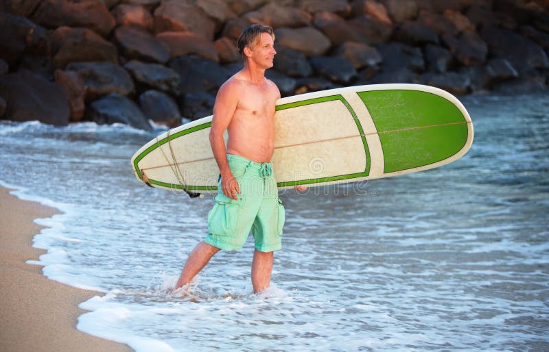 Surfer Walking into Water stock image. Image of shorts - 57927293
