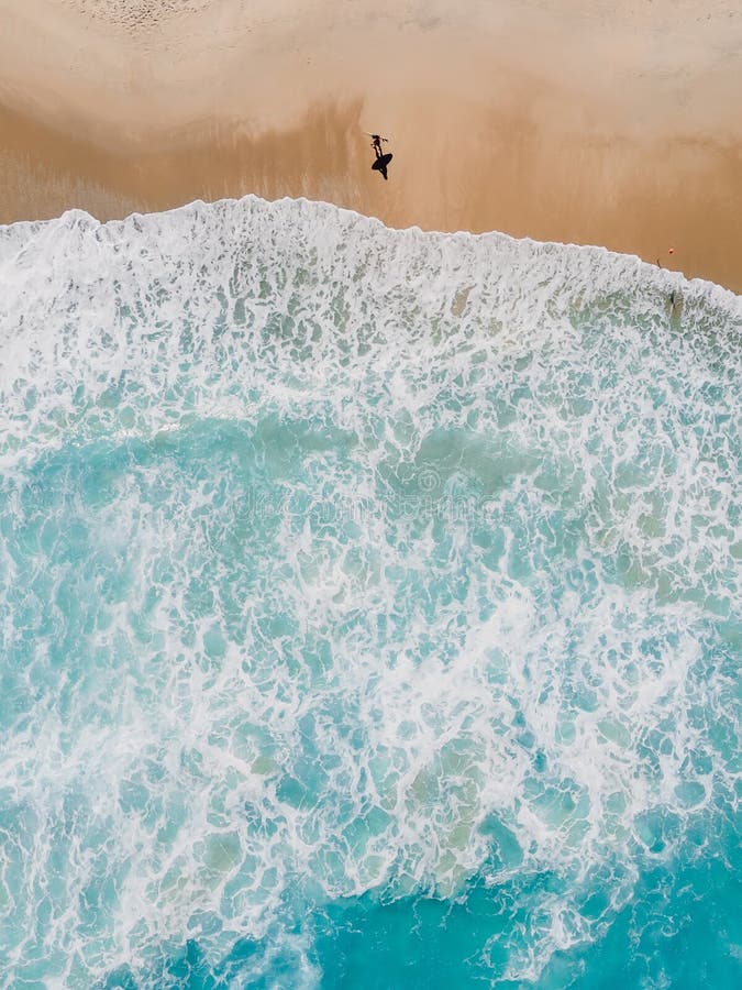 Surfer Walks on Sandy Beach with Ocean and Waves. Aerial View, Top Down ...