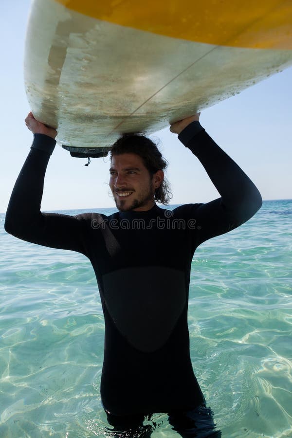 Surfer in Wetsuit Carrying Surfboard Over Head at Beach Coast Stock ...