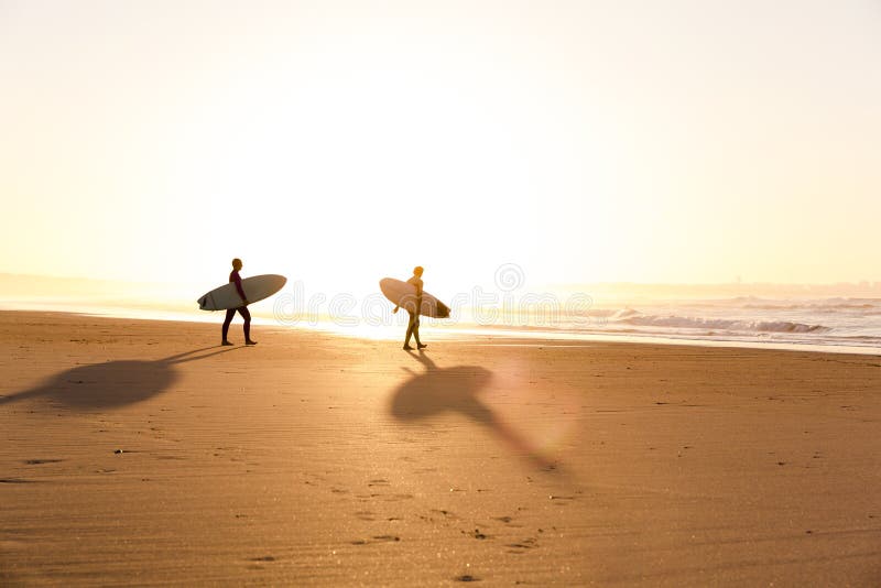 Surfers on the beach stock photo. Image of ocean, sunny - 97183358