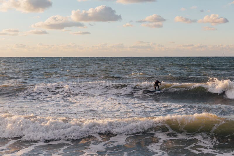 Surfers on Boards Riding the Waves in a Storm at Sea Stock Image ...