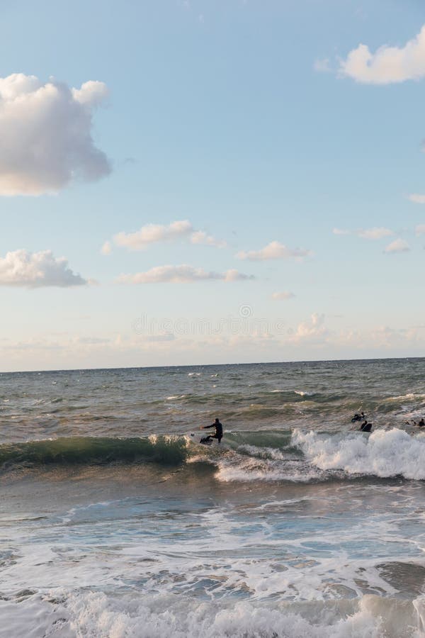 Surfers on Boards Riding the Waves in a Storm at Sea Stock Photo ...