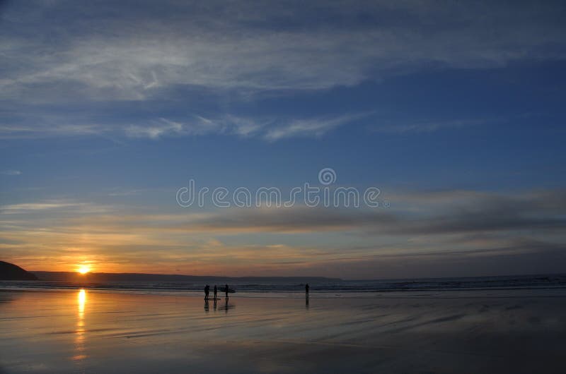 Surfers at sunset stock photo. Image of sand, ocean, devon - 48466534