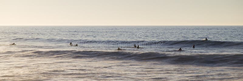 Surfers waiting for a wave stock photo. Image of panorama - 100854164