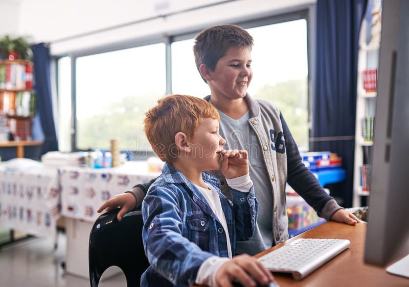 Surfing the Internet with My Buddy. Elementary School Children in Class ...