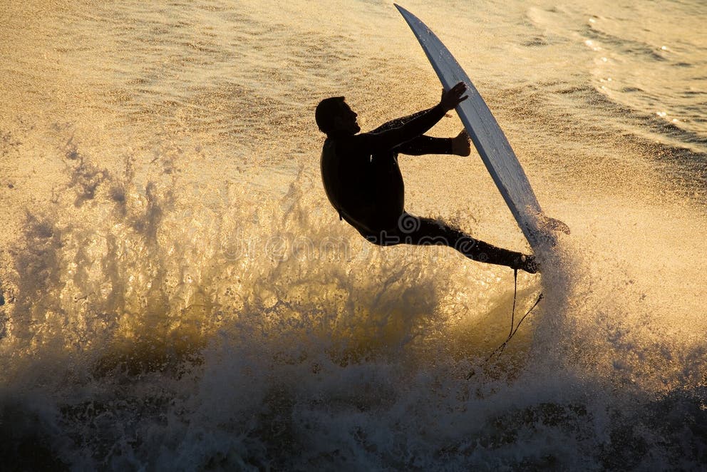 Surfing at Sunset stock image. Image of jump, daring, hanging - 612995
