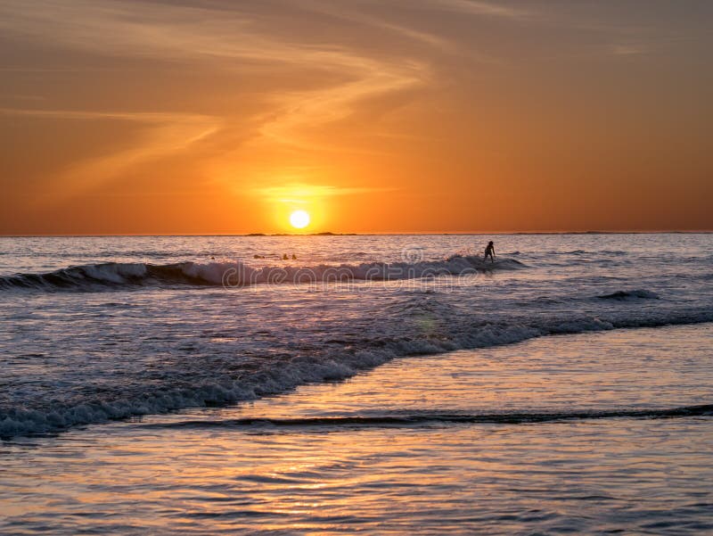 Surfing at Sunset stock photo. Image of adventure, girl - 66682672