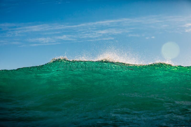 Surfing Wave with Drops. Breaking Ocean Wave with Sunshine Stock Image ...