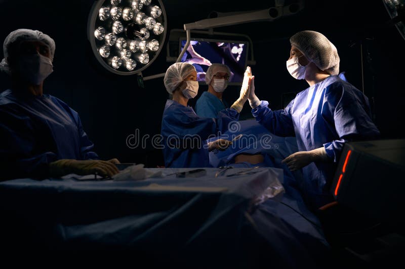 Surgeon and the Assistant Give High Five after Successful Operation ...